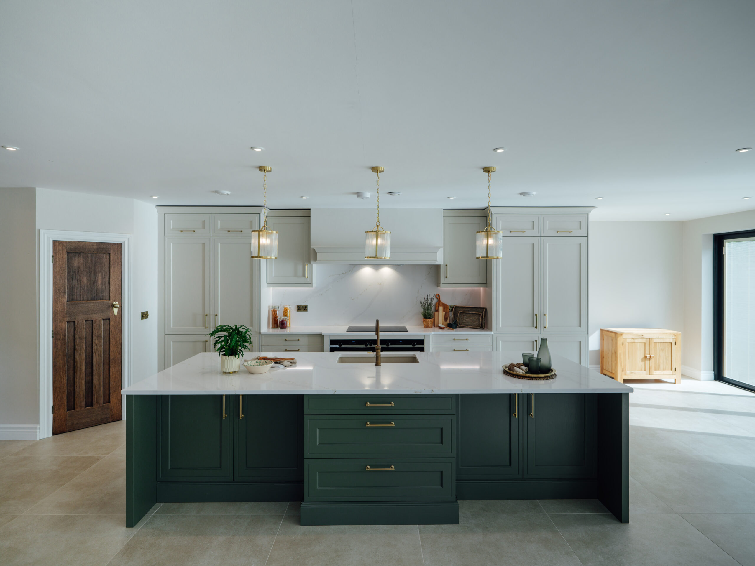 An emerald isle, in Pedmore. Green kitchen islands by The Gallery